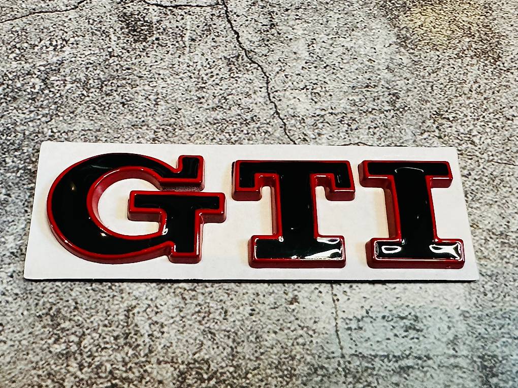 VW GTI Emblem Logo Schriftzug NEU in Schwarz/Rot aus Metall im Kanton ...